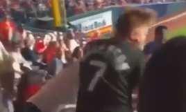 What does the 'horns down' symbol mean in college football?